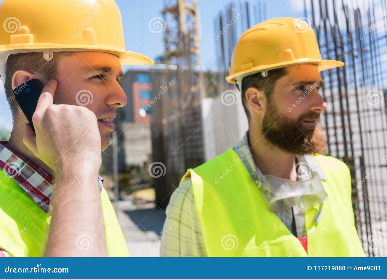 Worker Talking on Mobile Phone during Work on a Construction Site Stock ...