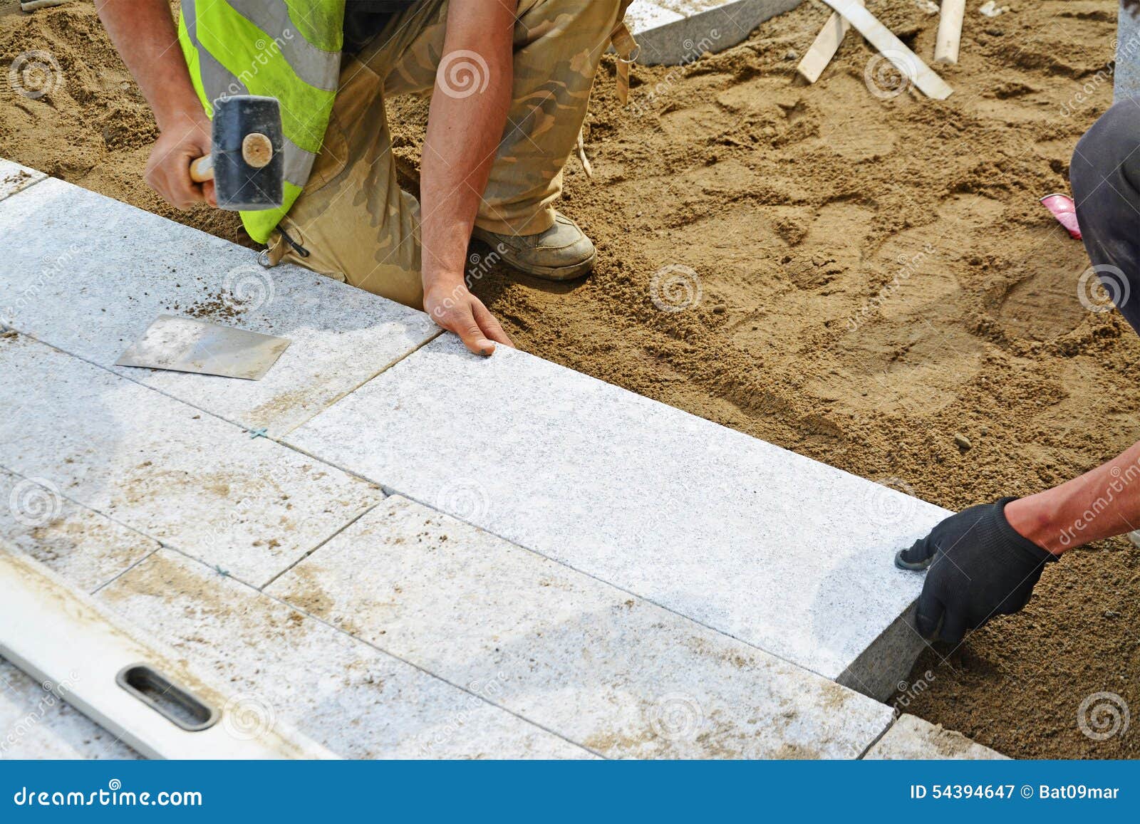 Worker Tapping Paver into Place with Rubber Mallet. Stock Image - Image ...