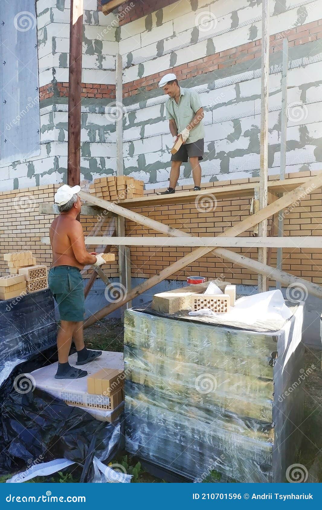 A Worker Throws Bricks at Another Worker, Construction Work in a ...