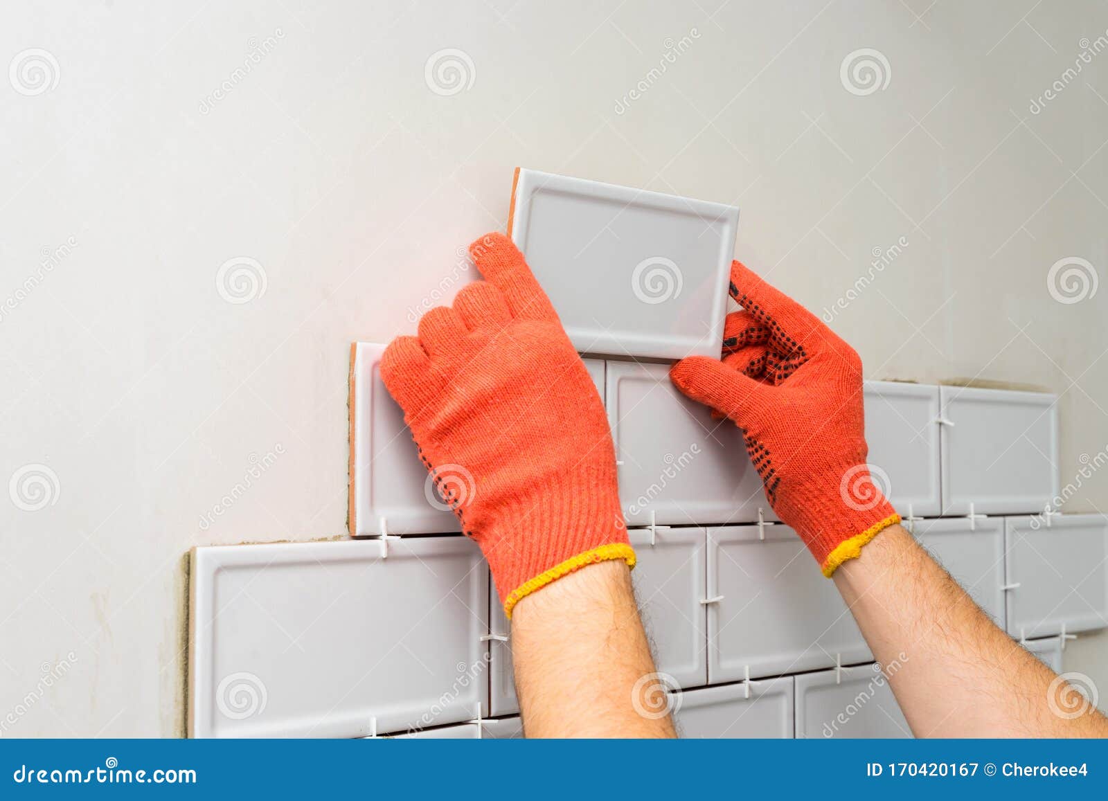 Worker is Tiling the White Tiles on the Kitchen Wall. Concept of a ...
