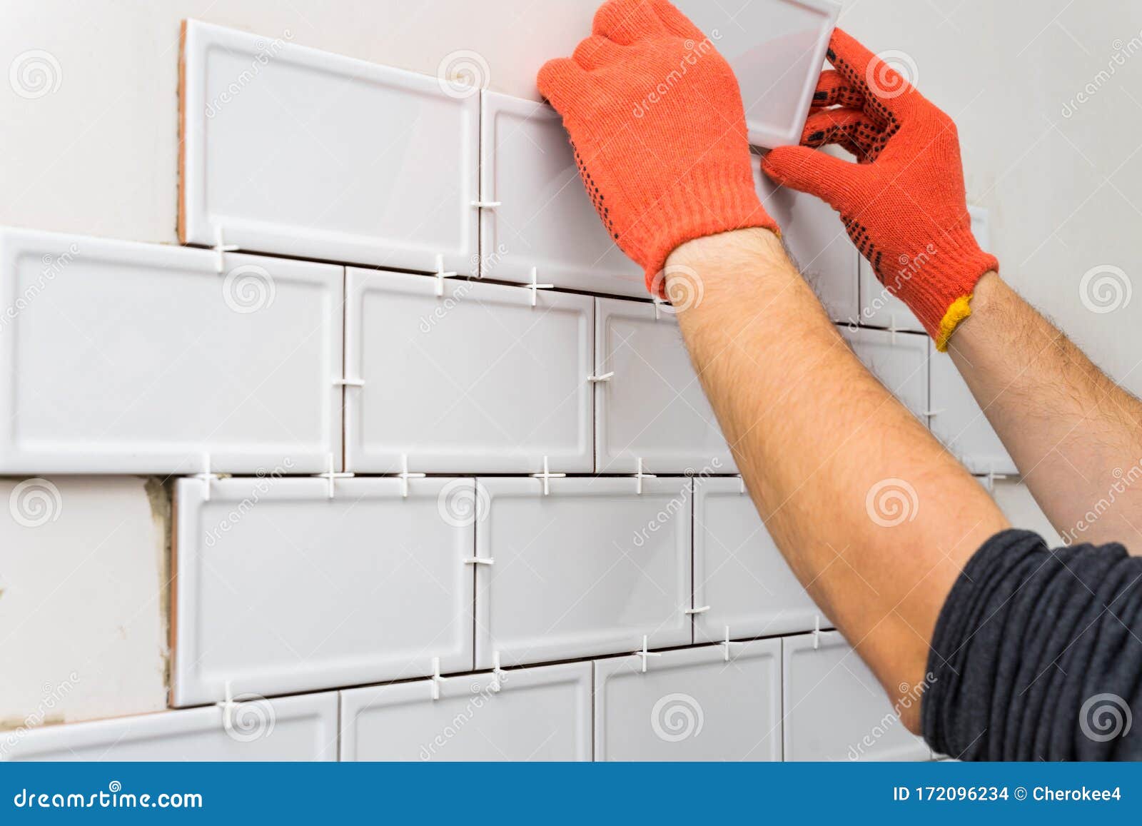 Worker is Tiling the White Tiles on the Kitchen Wall. Concept of a ...