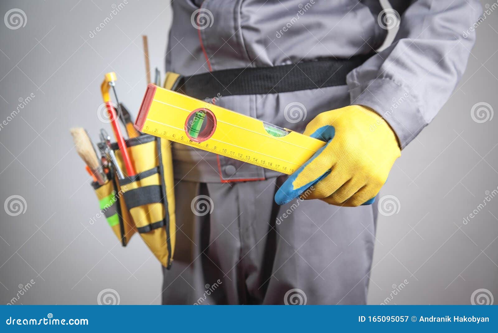 Worker with a Tool Belt Holding Level. Construction Tools Stock Image ...