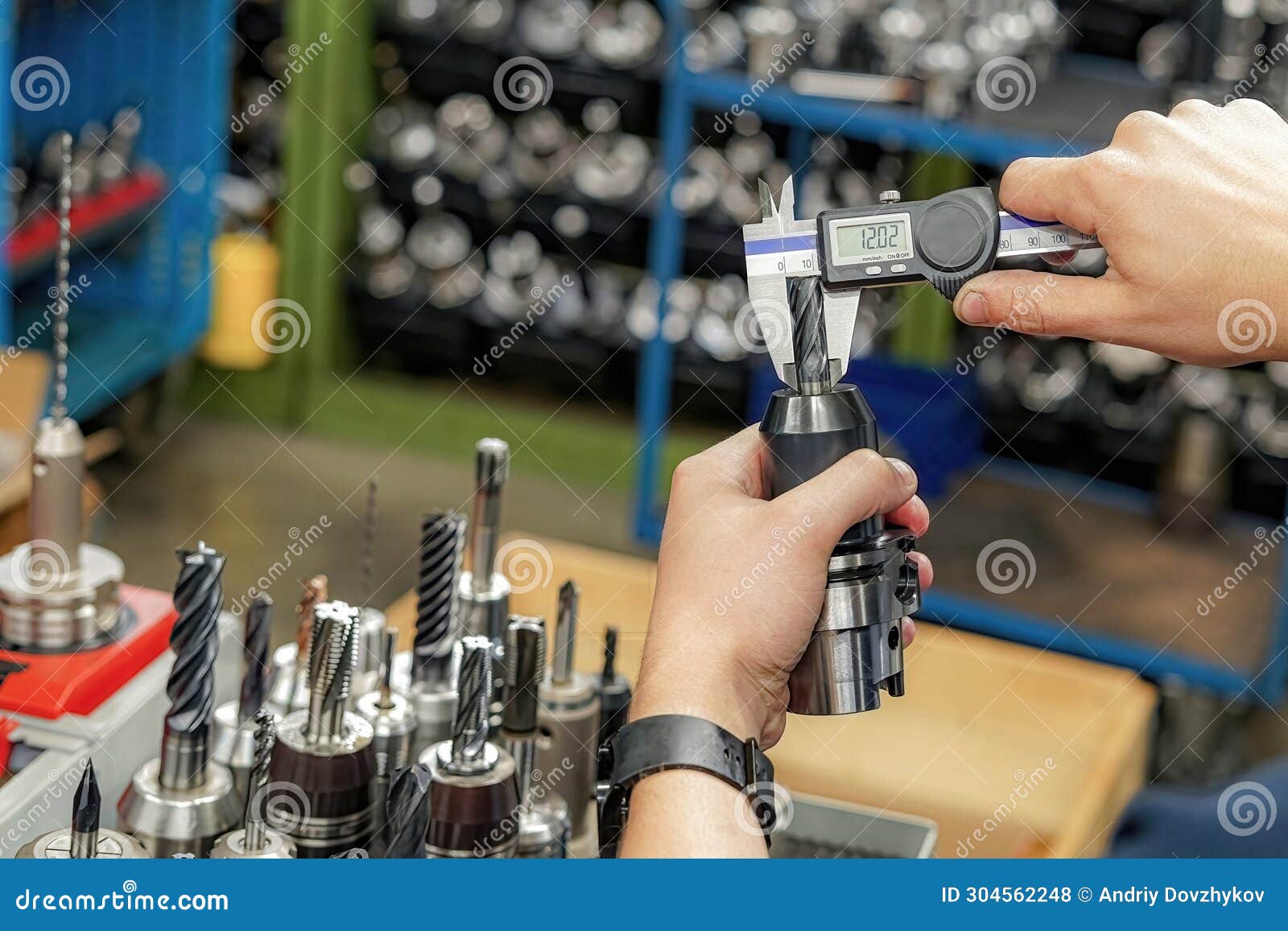 A Worker in a Tool Warehouse Inspects and Selects Cutters for Work on a ...