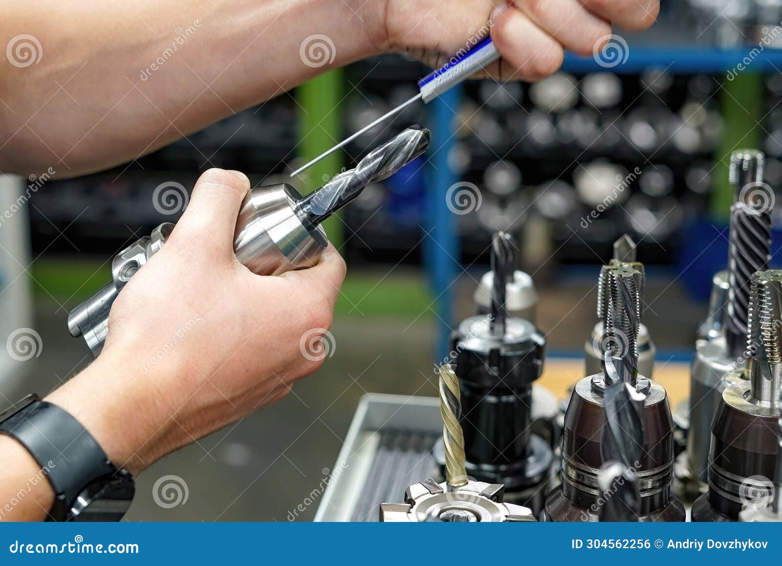 A Worker in a Tool Warehouse Inspects and Selects Cutters for Work on a ...