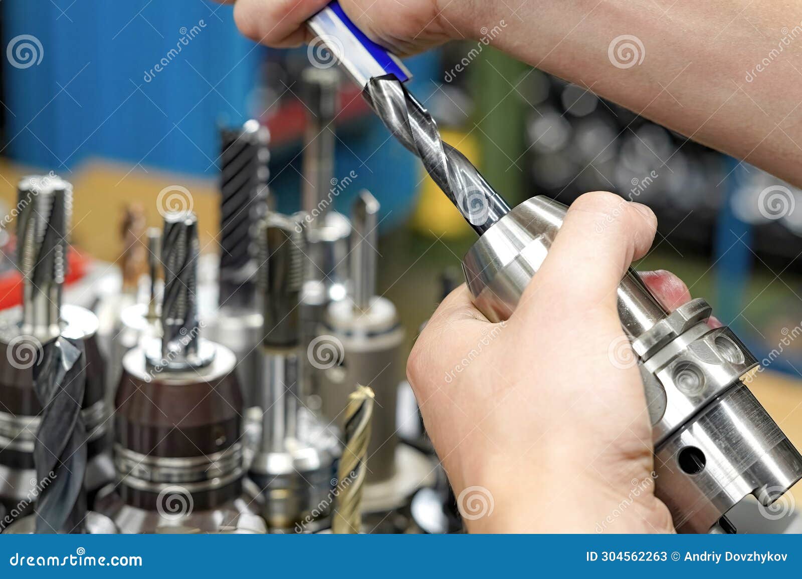 A Worker in a Tool Warehouse Inspects and Selects Cutters for Work on a ...