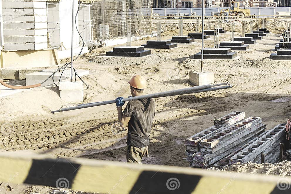 A Worker Transfers Elements for the Installation of the Formwork at the ...