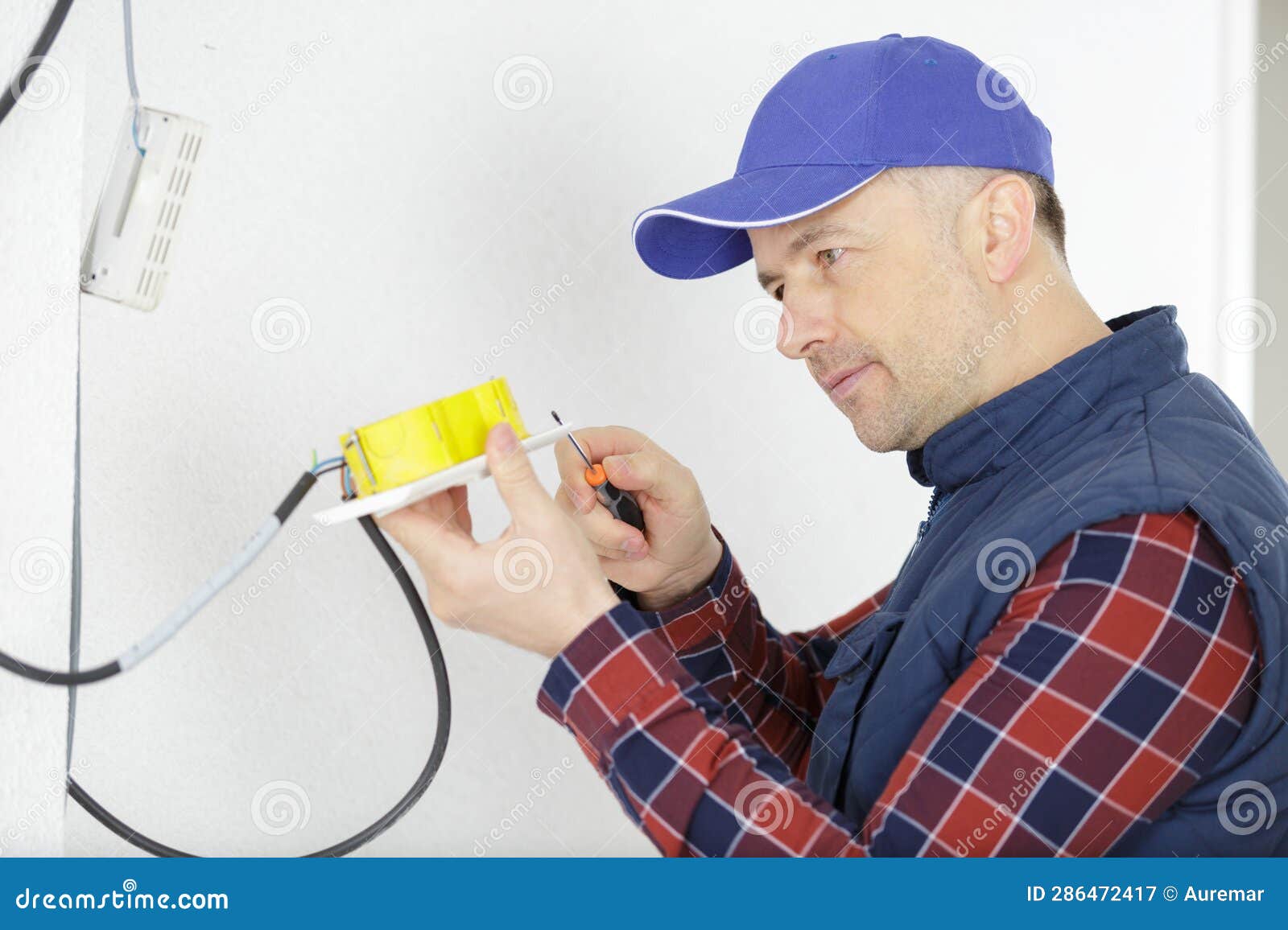 Worker Trying To Install Wires on Wall Stock Image - Image of room ...