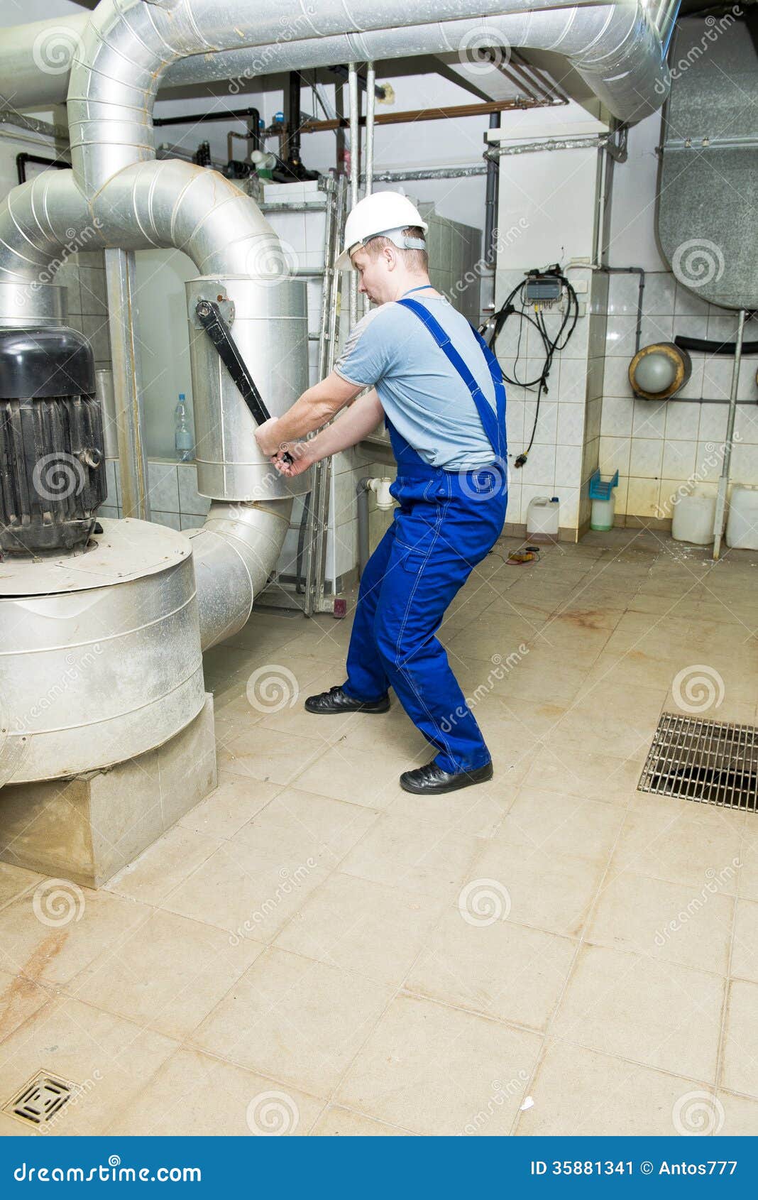 Worker turns a valve stock image. Image of service, silver - 35881341