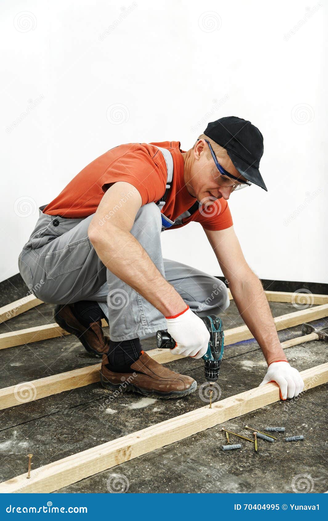 Worker twists the screw. stock image. Image of building - 70404995