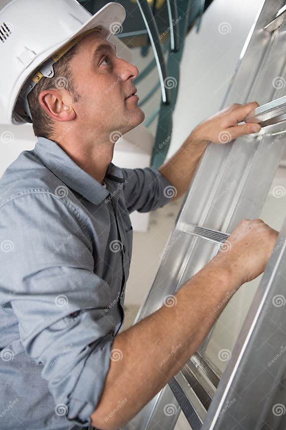 Worker in Uniform Going Up Ladder Stock Photo - Image of closeup ...