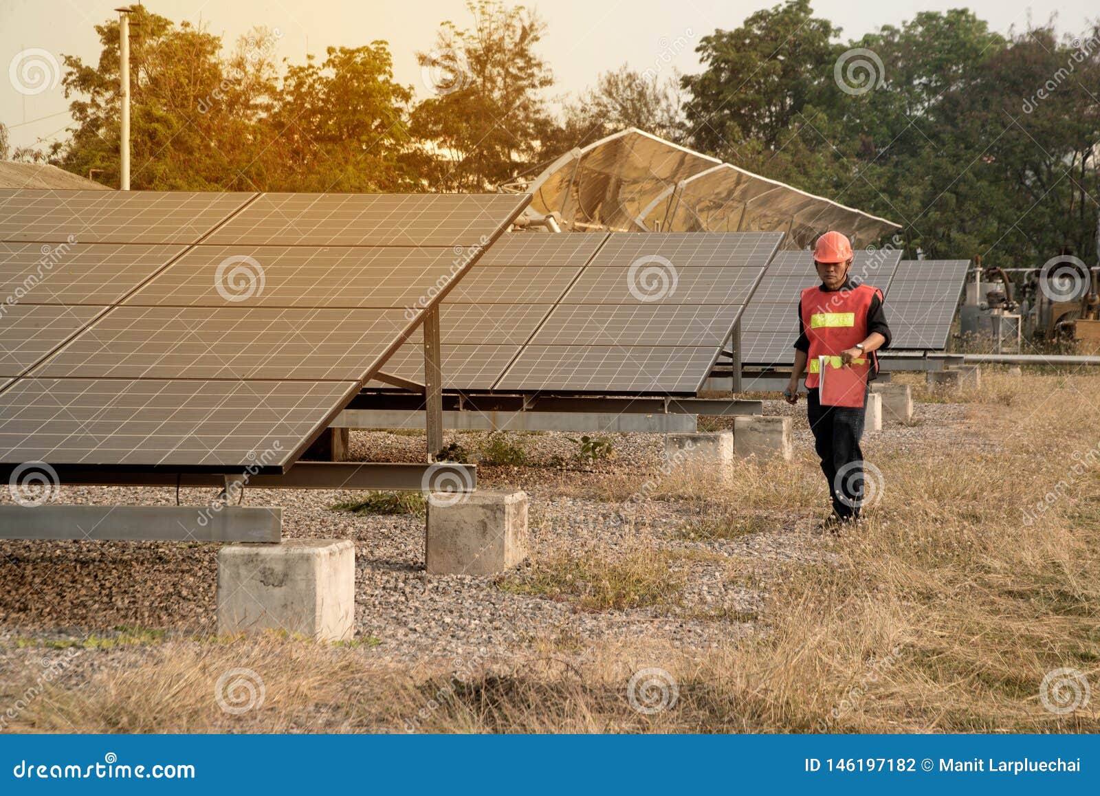 The Worker in Uniform and Helmet Checks Solar Cell. Stock Photo - Image ...