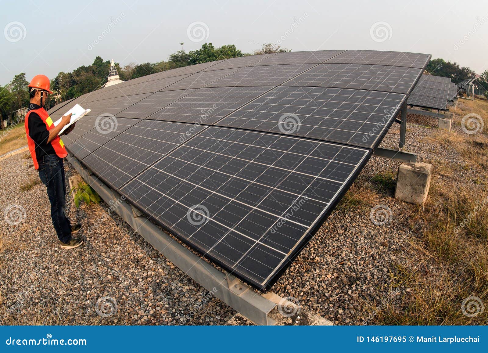 The Worker in Uniform and Helmet Checks Solar Cell. Stock Image - Image ...