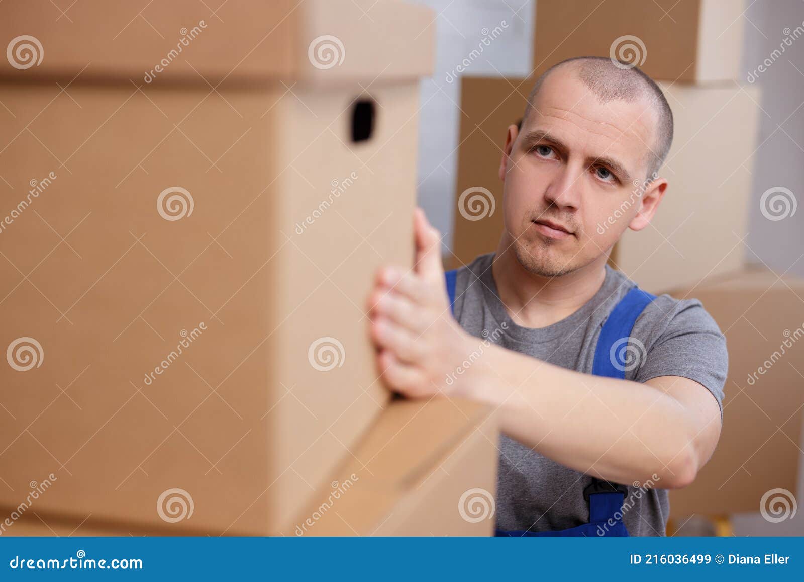 Worker in Uniform Holding Big Box in Warehouse Stock Image - Image of ...