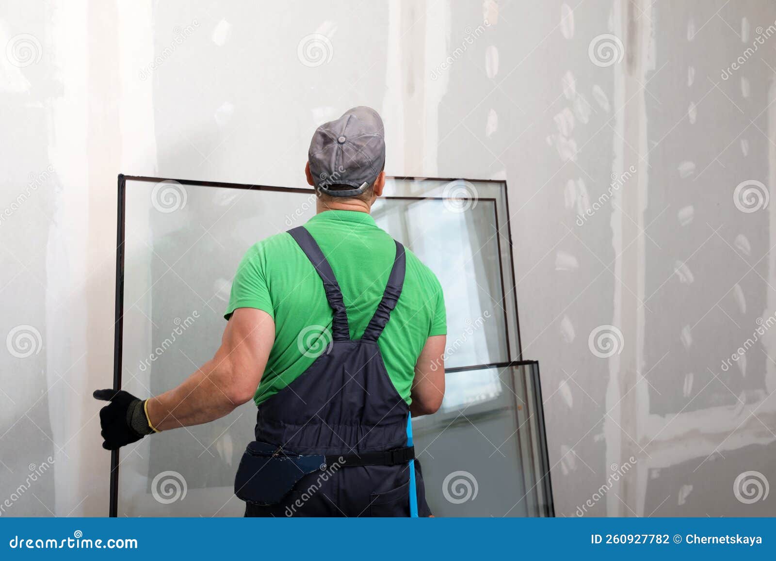 Worker in Uniform Holding Double Glazing Window Indoors, Back View ...