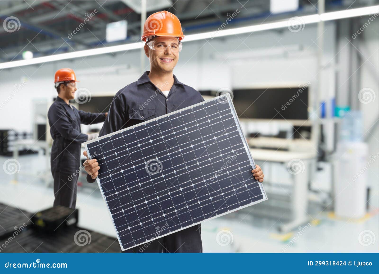 Worker in a Uniform Holding a Solar Panel in a Factory Stock Photo ...