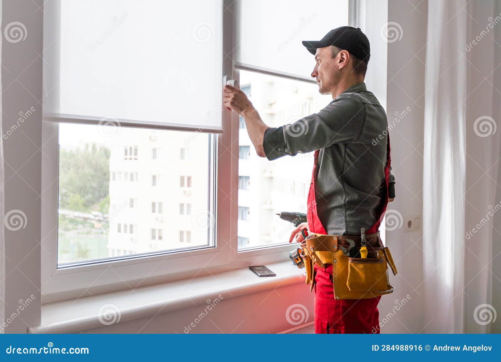 Worker in Uniform Installing Blinds on Plastic Upvc Window. Stock Photo ...