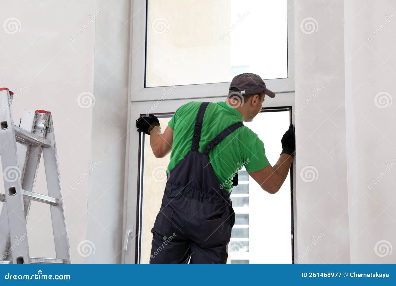 Worker in Uniform Installing Double Glazing Window Indoors, Back View ...