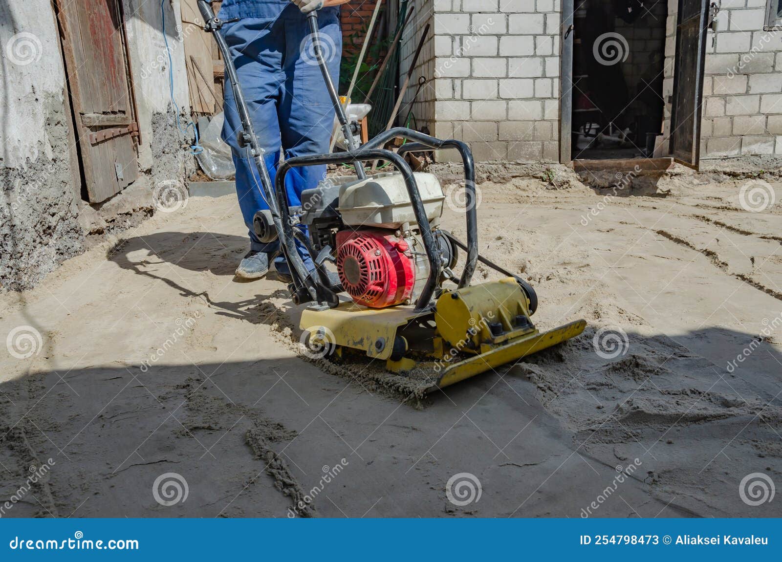 Worker in Uniform and Knee Pads Use Vibratory Plate Compactor for Path ...