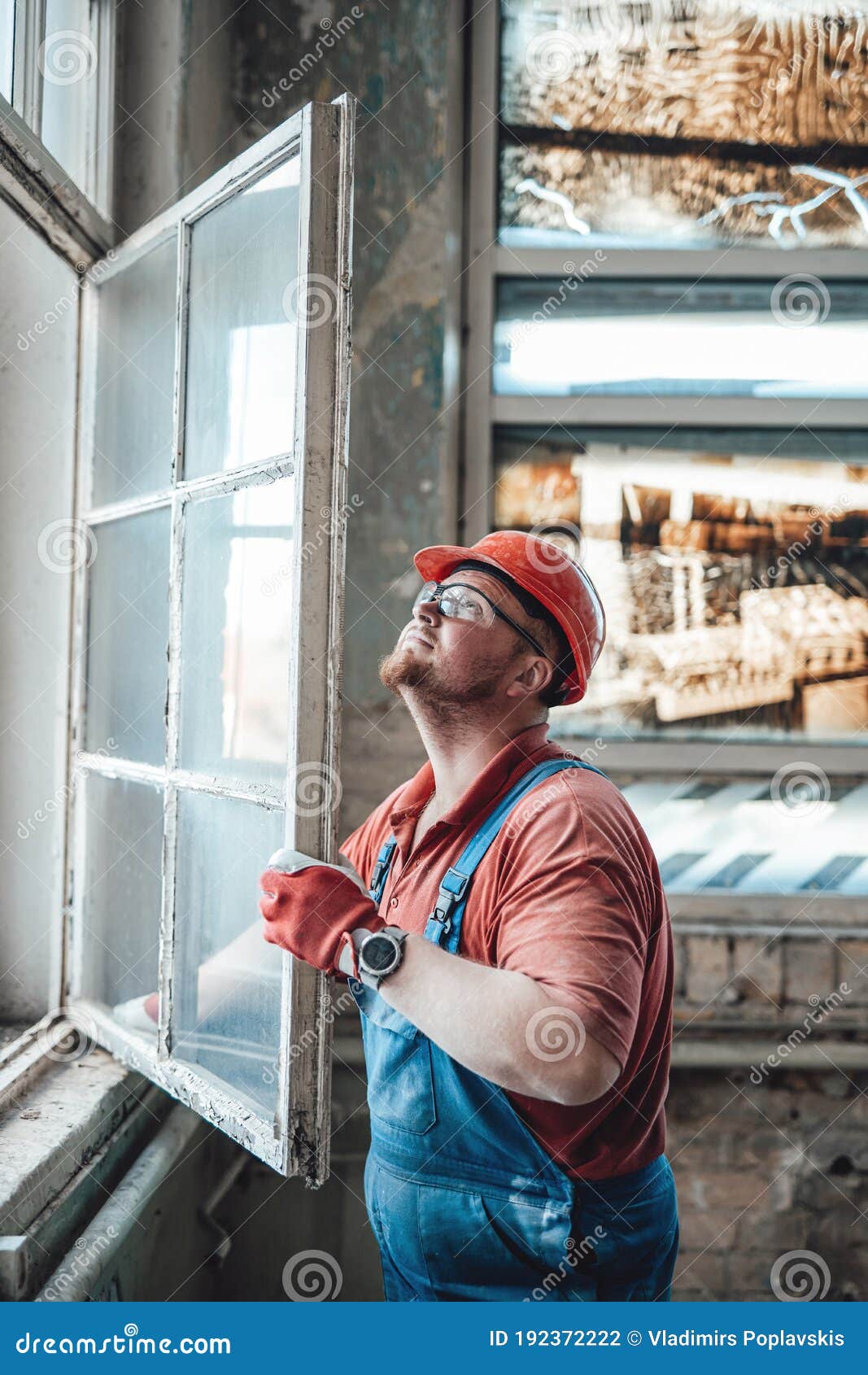 Builder Working with a Window at a Construction Site Stock Photo ...