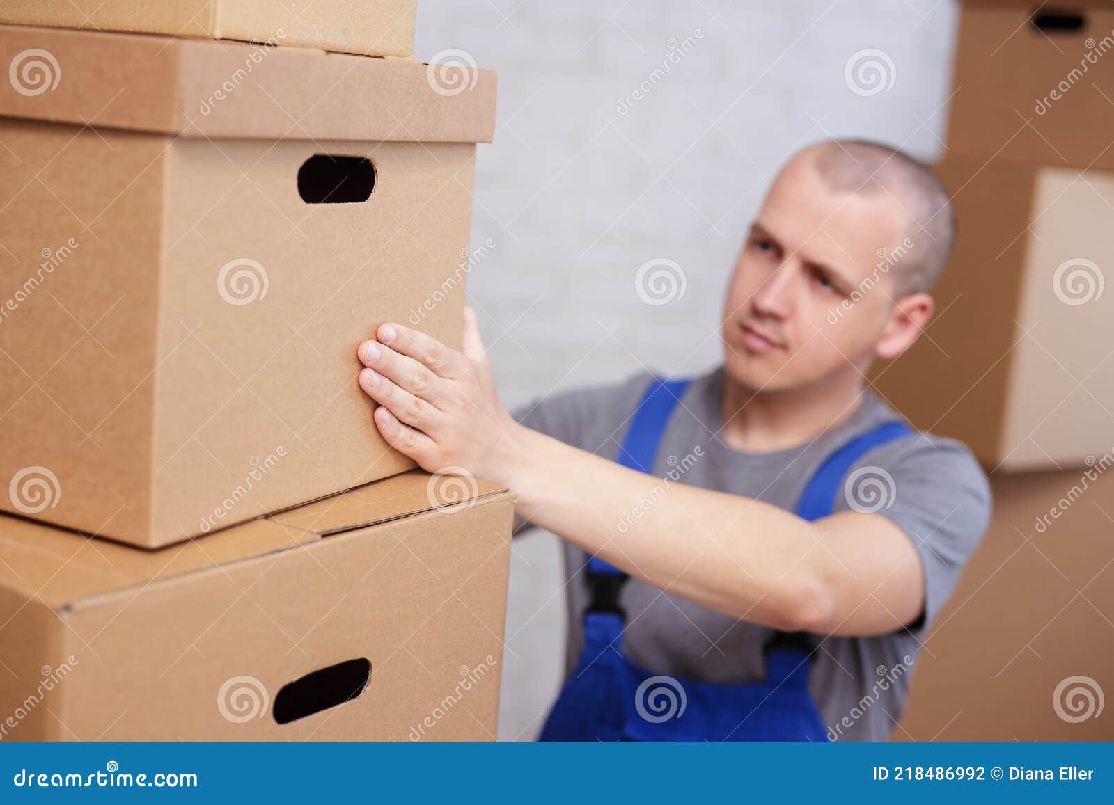 Worker in Uniform Taking Big Box from Shelf in Warehouse Stock Photo ...
