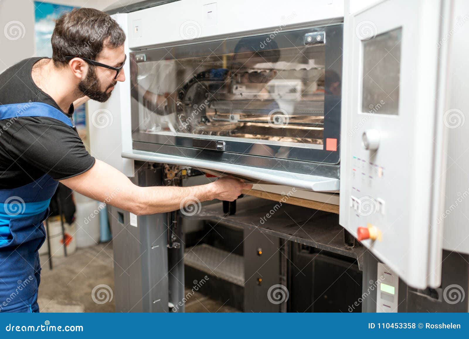 Man Working with Printing Machine at the Manufacturing Stock Photo ...