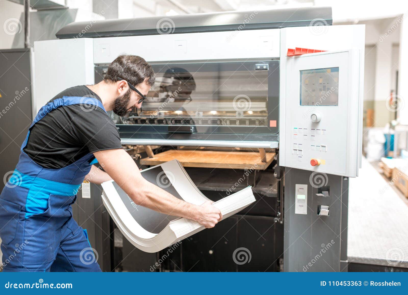 Man Working with Printing Machine at the Manufacturing Stock Image ...