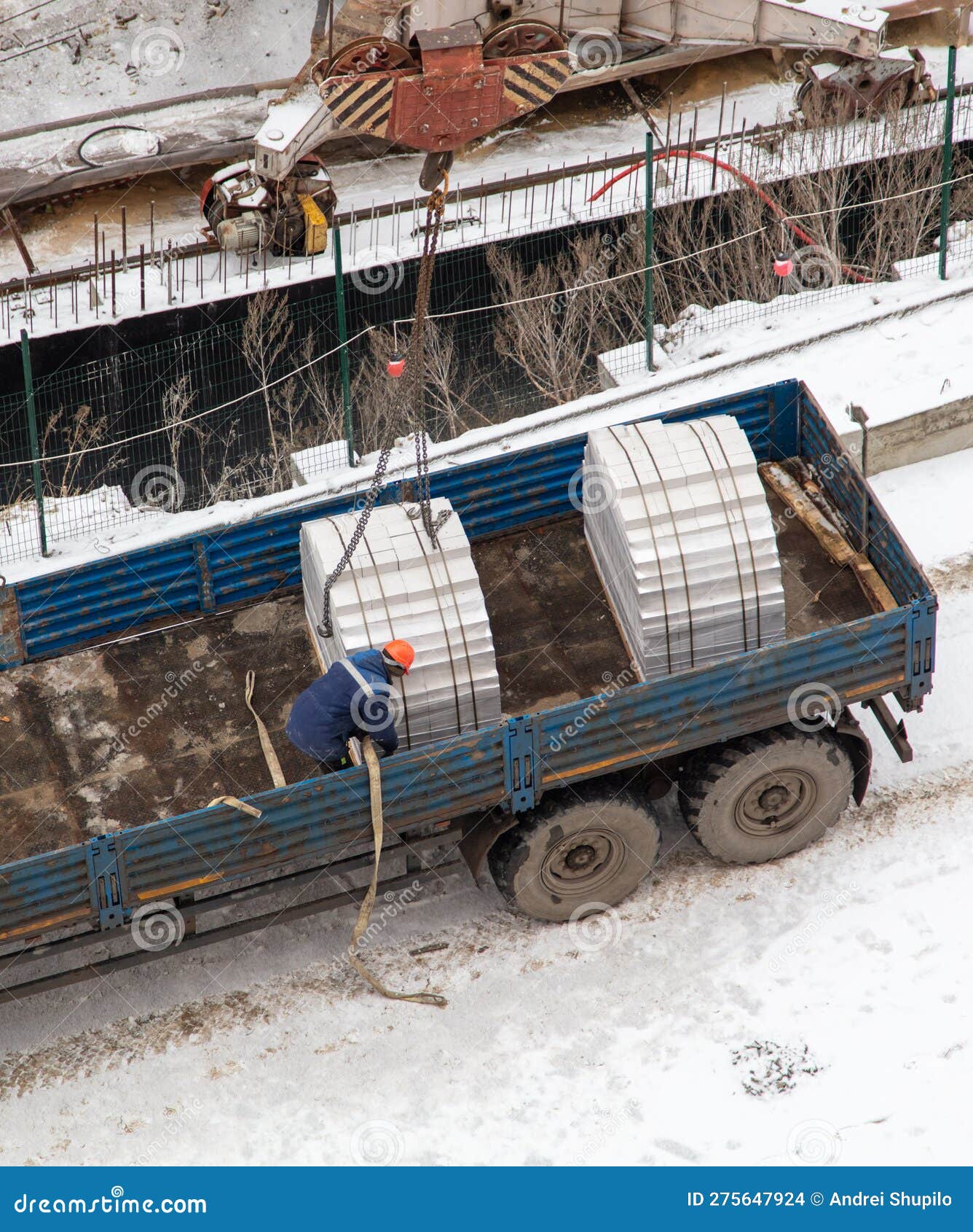 A Worker is Unloading Bricks in a Truck at a Construction Site Stock ...
