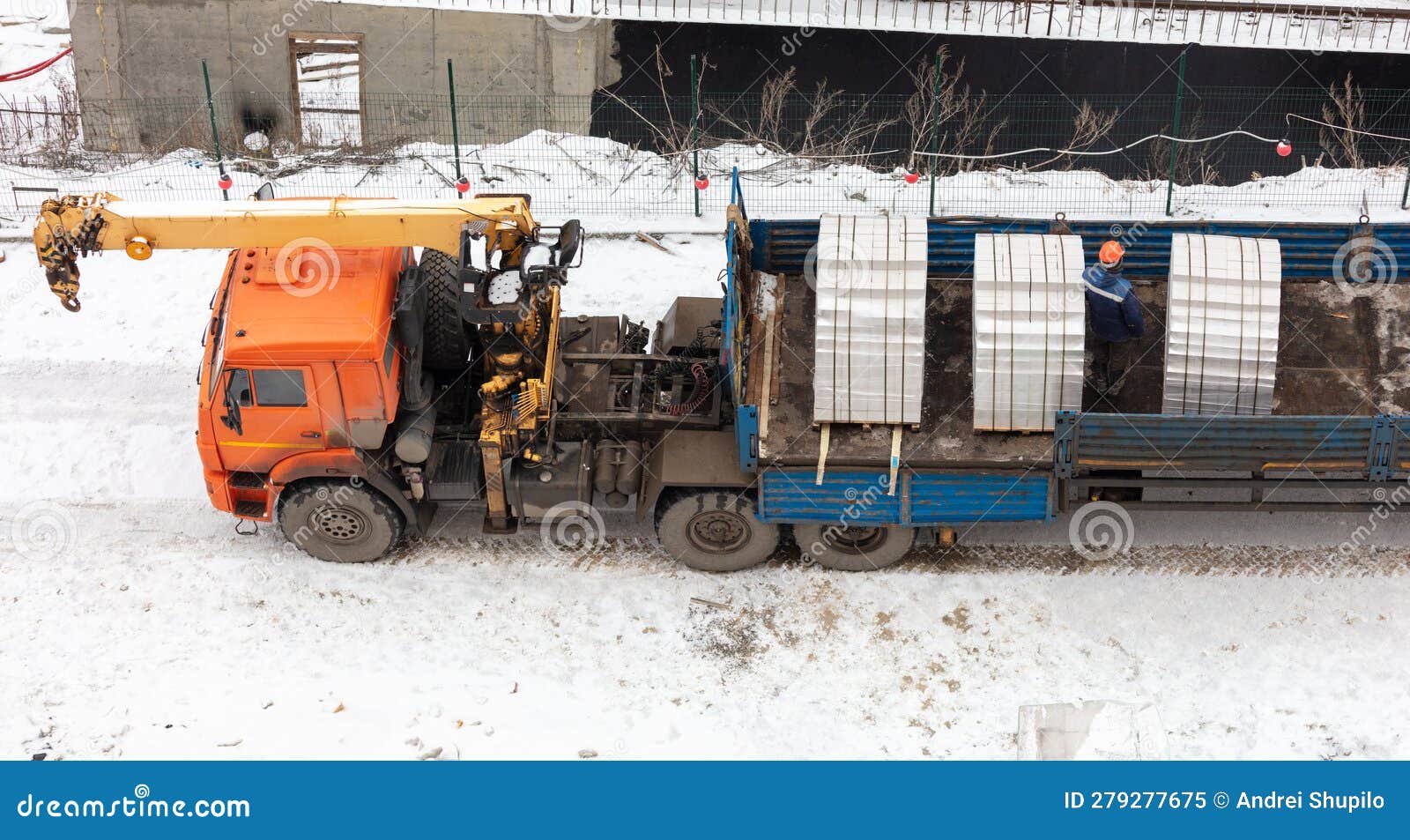 A Worker is Unloading Bricks in a Truck at a Construction Site Stock ...