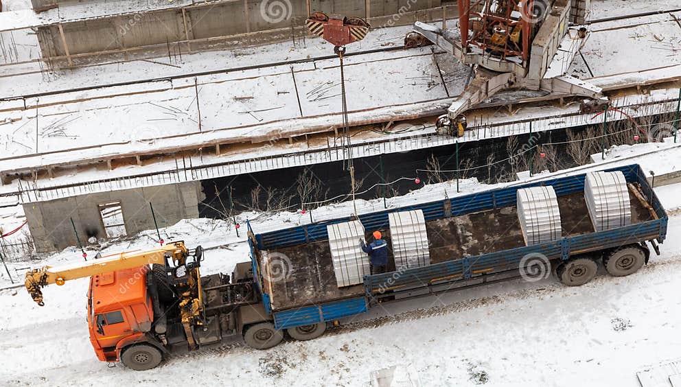 A Worker is Unloading Bricks in a Truck at a Construction Site Stock ...