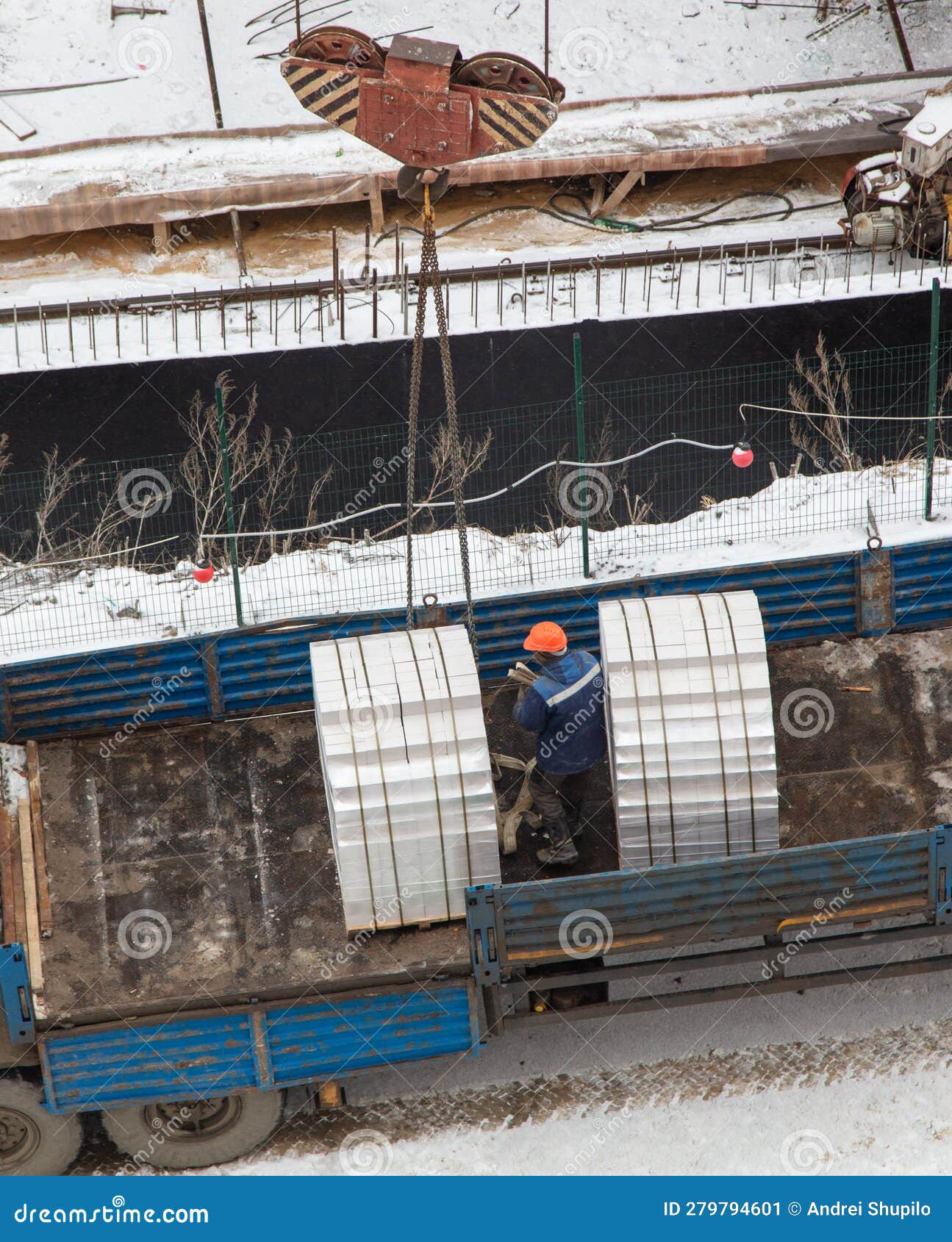 A Worker is Unloading Bricks in a Truck at a Construction Site Stock ...