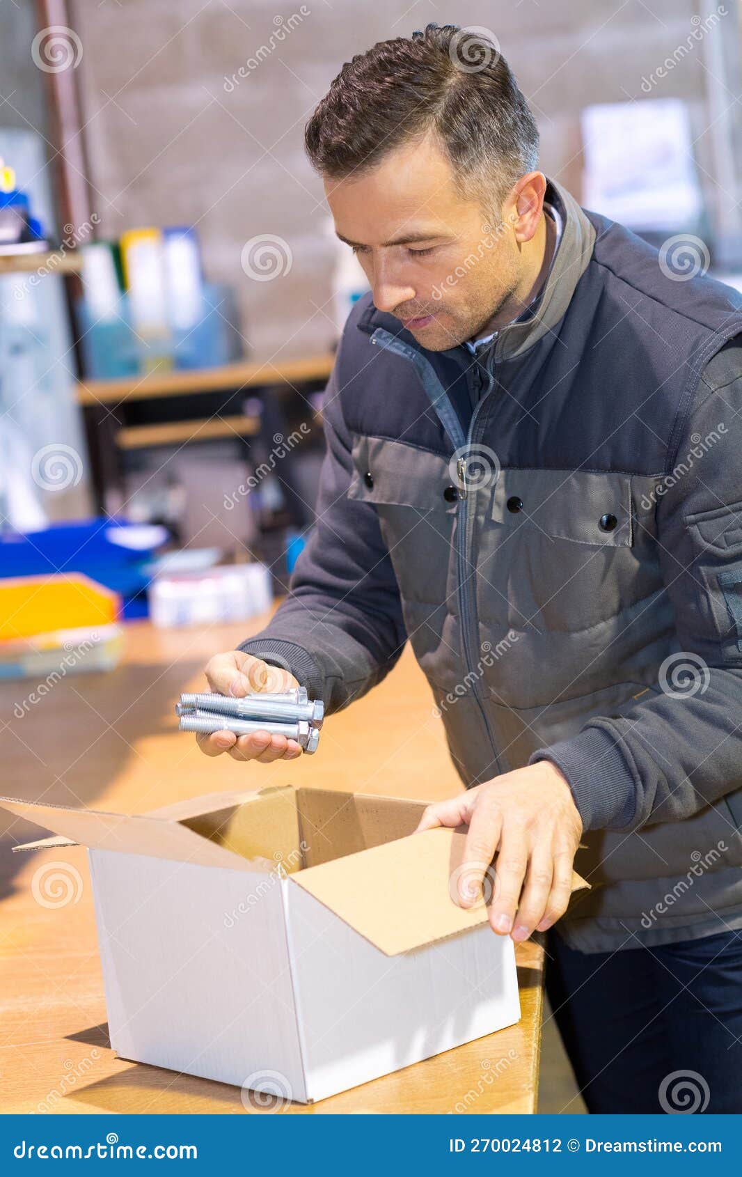 Worker Unpacking Bolts from Delivery in Cardboard Box Stock Photo ...