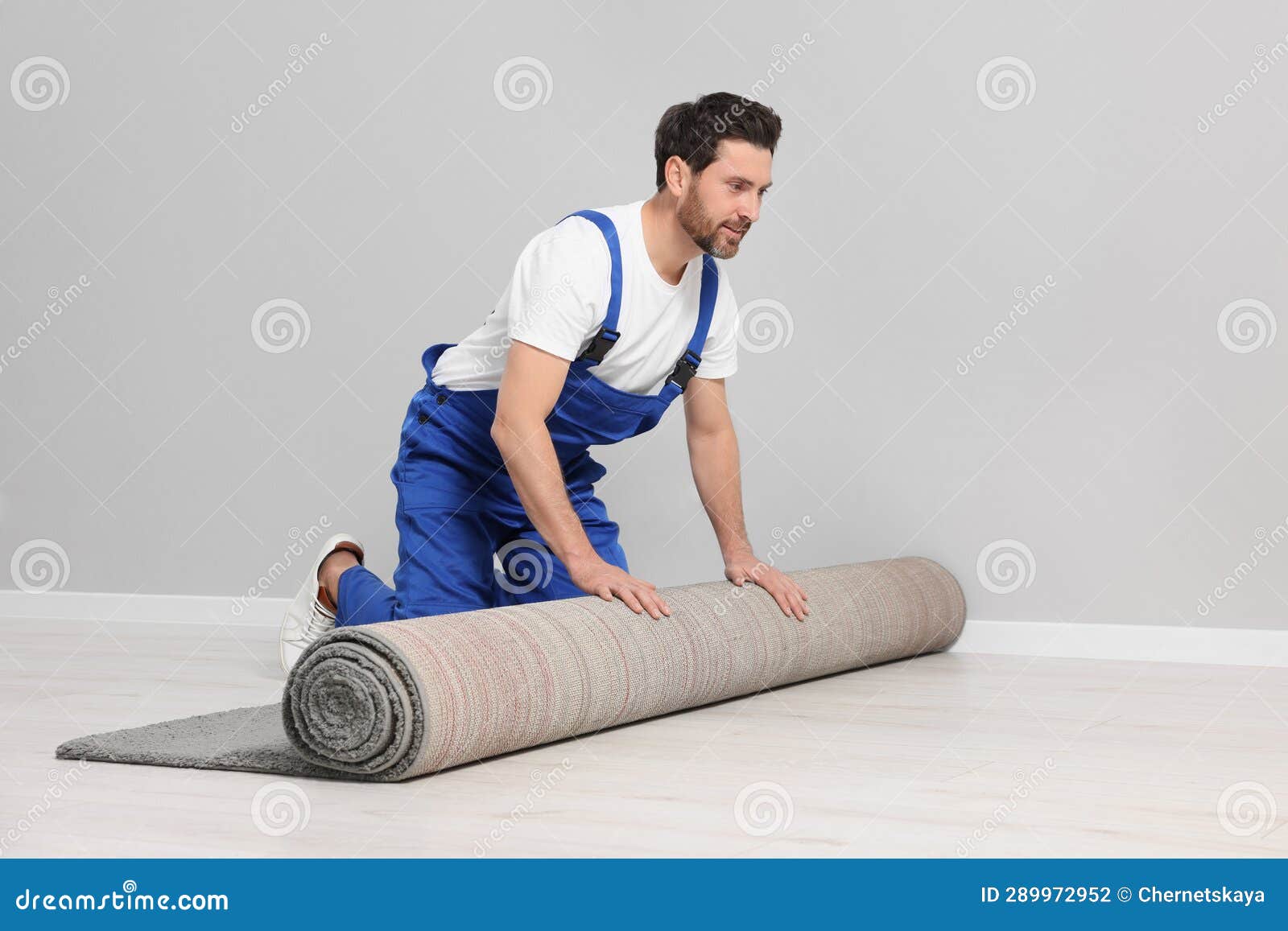 Worker Unrolling New Clean Carpet in Room Stock Photo - Image of ...