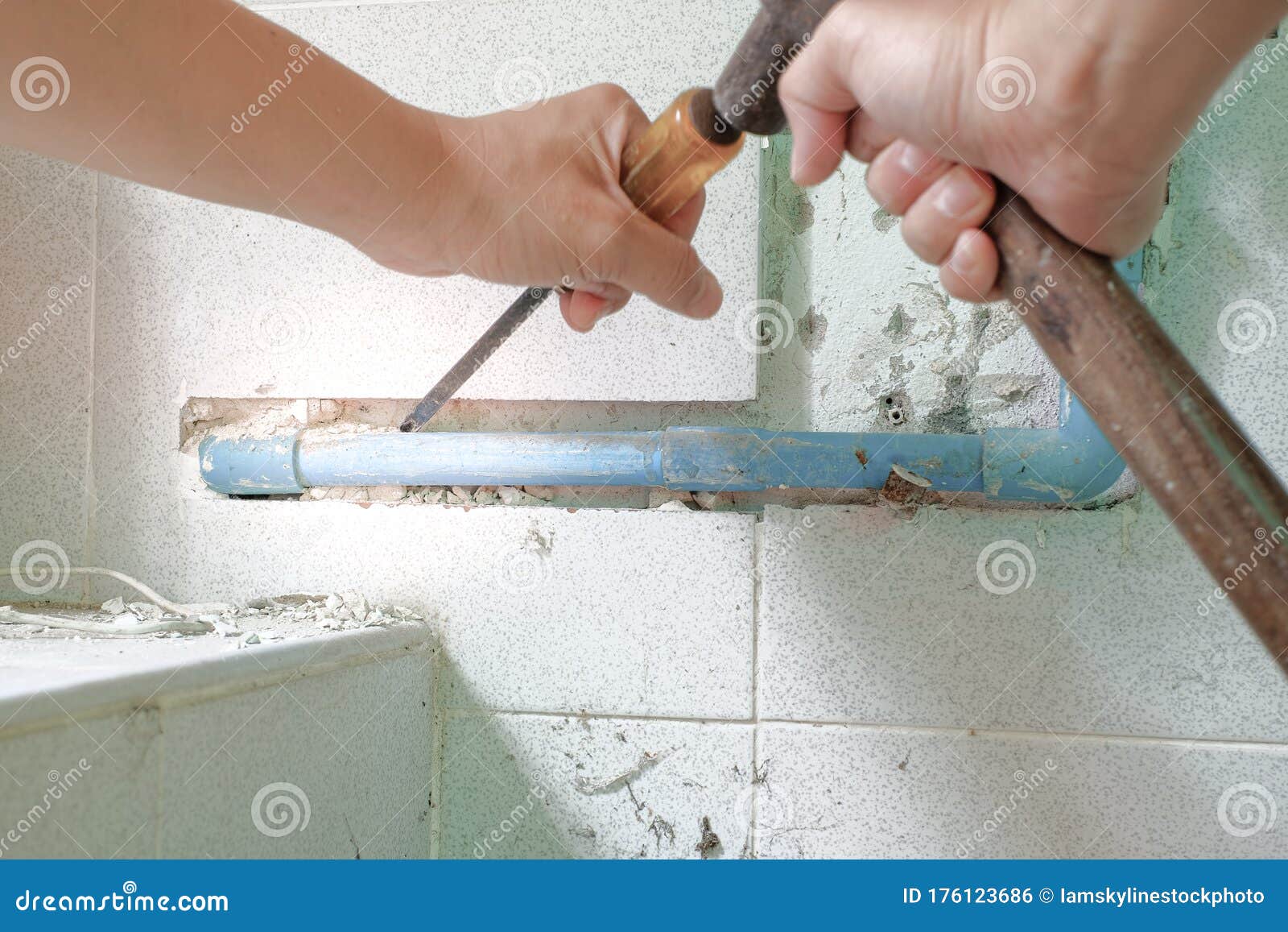 Worker Use Chisel To Remove the Tile and Pipe from the Wall Stock Photo ...