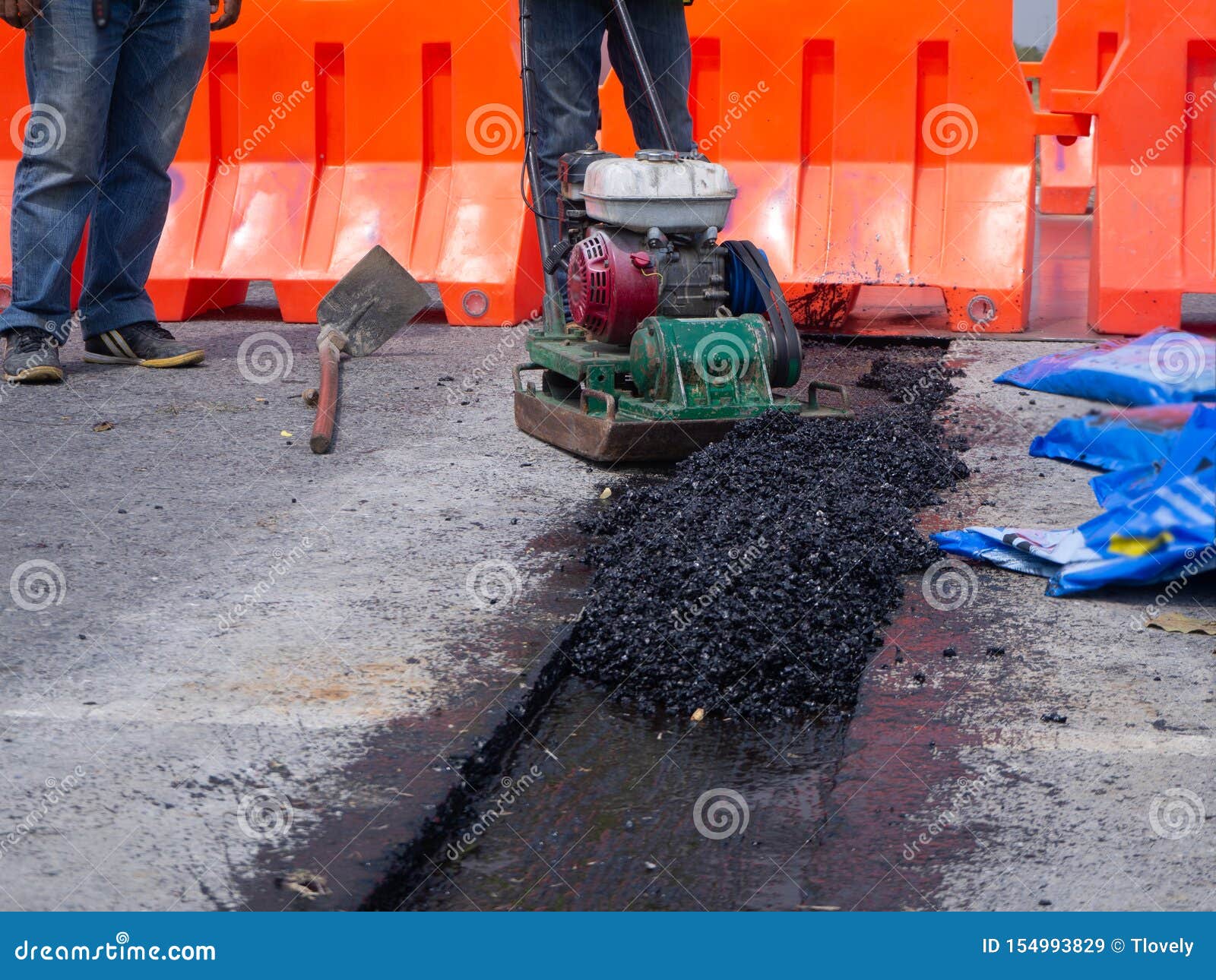 Worker Use Vibratory Plate Compactor Compacting Asphalt at Road Stock ...