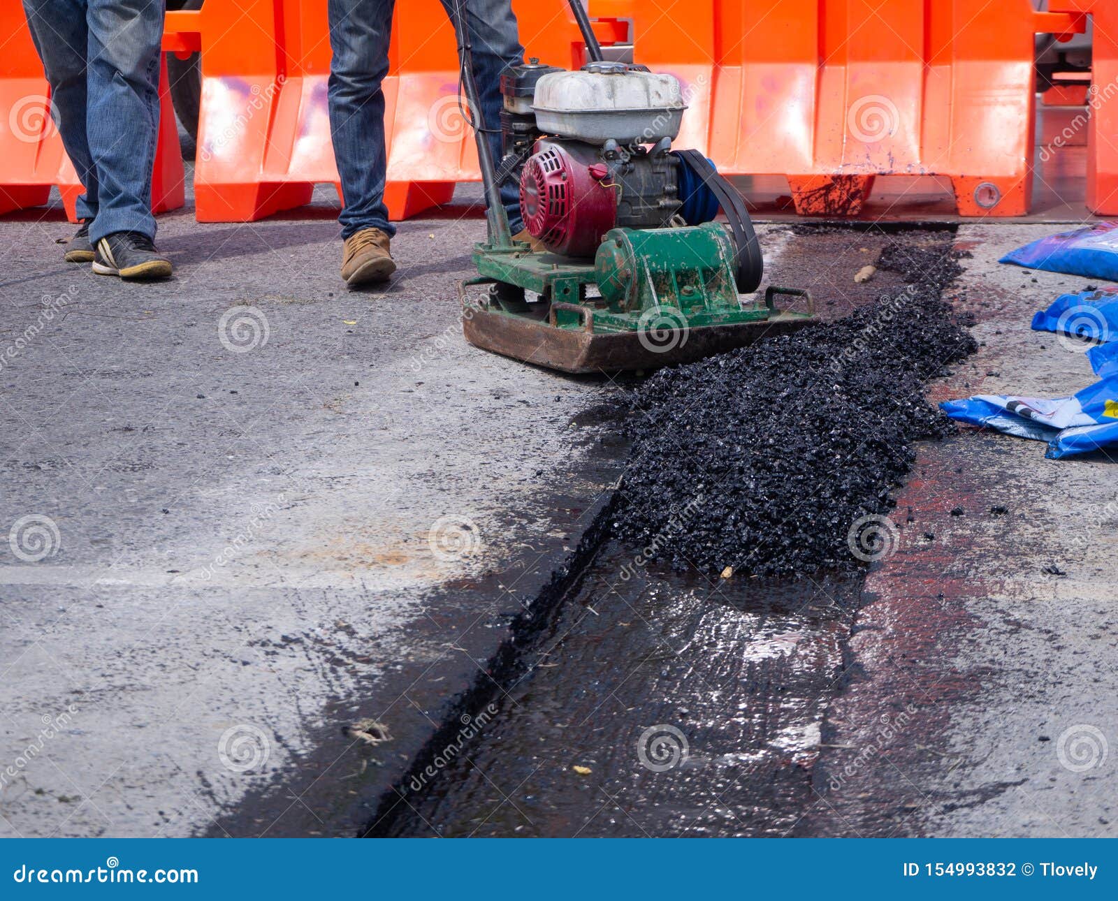 Worker Use Vibratory Plate Compactor Compacting Asphalt at Road Stock ...