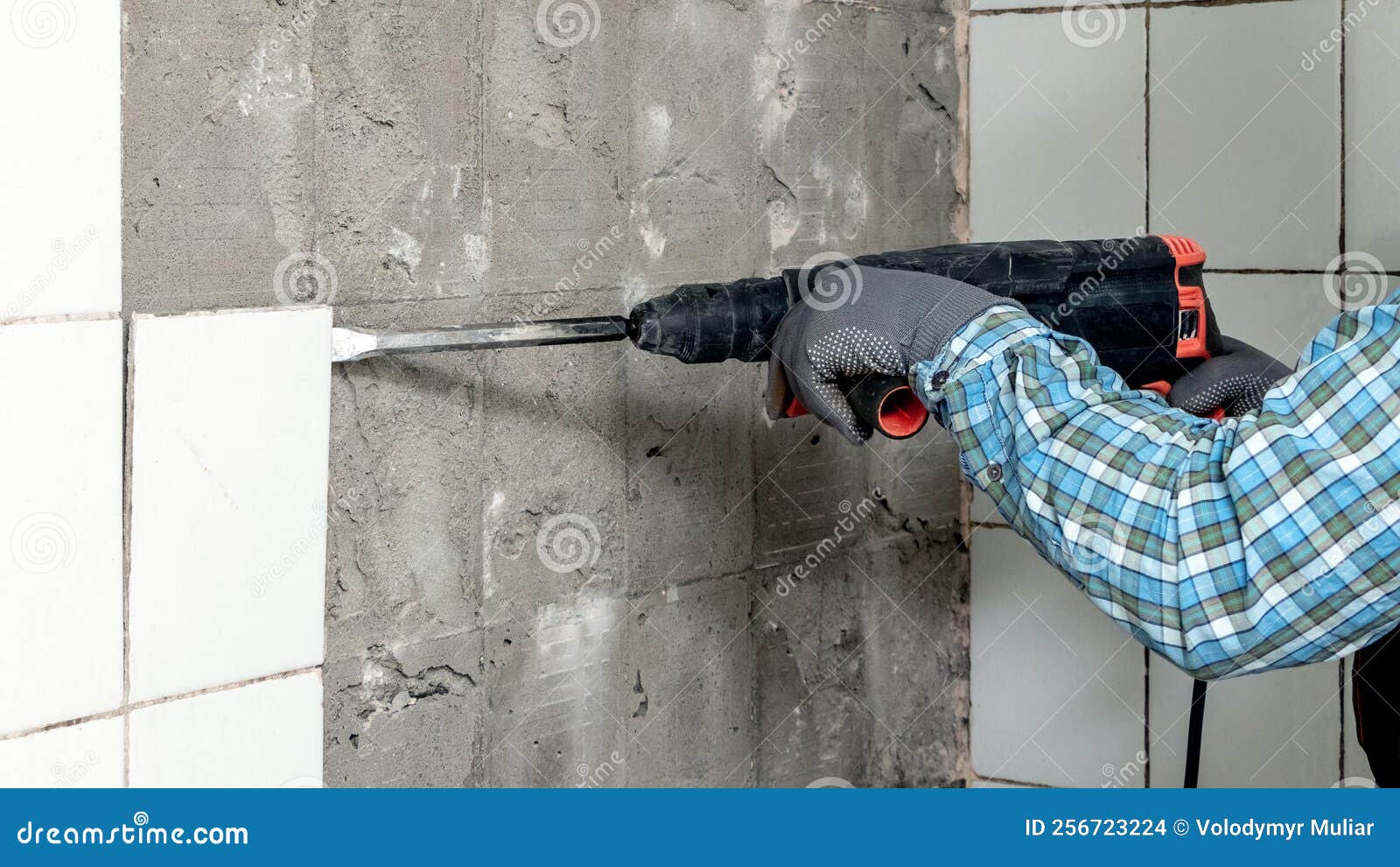 A Worker Uses a Perforator To Dismantle Facing Tiles in a Bathroom ...