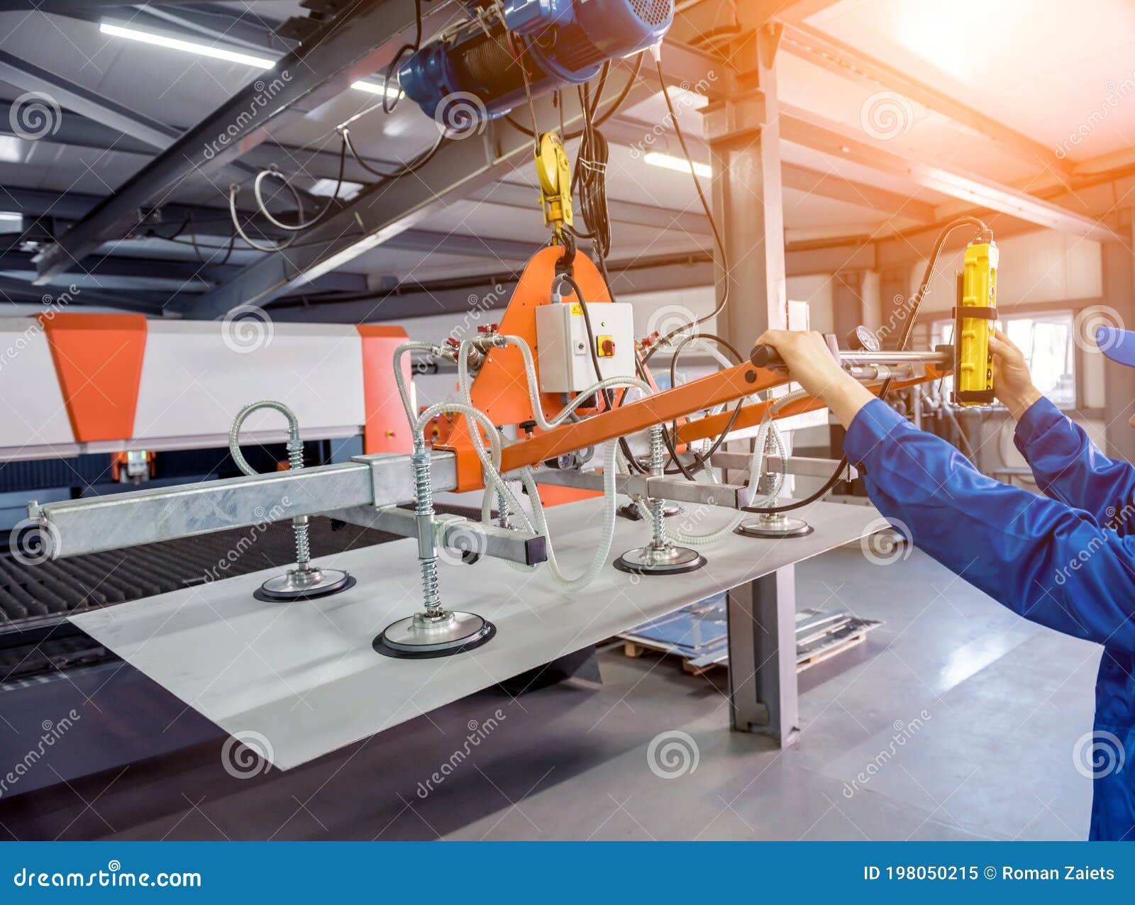 Worker Uses Suction Cups for Transporting Large Sheets of Metal Stock ...