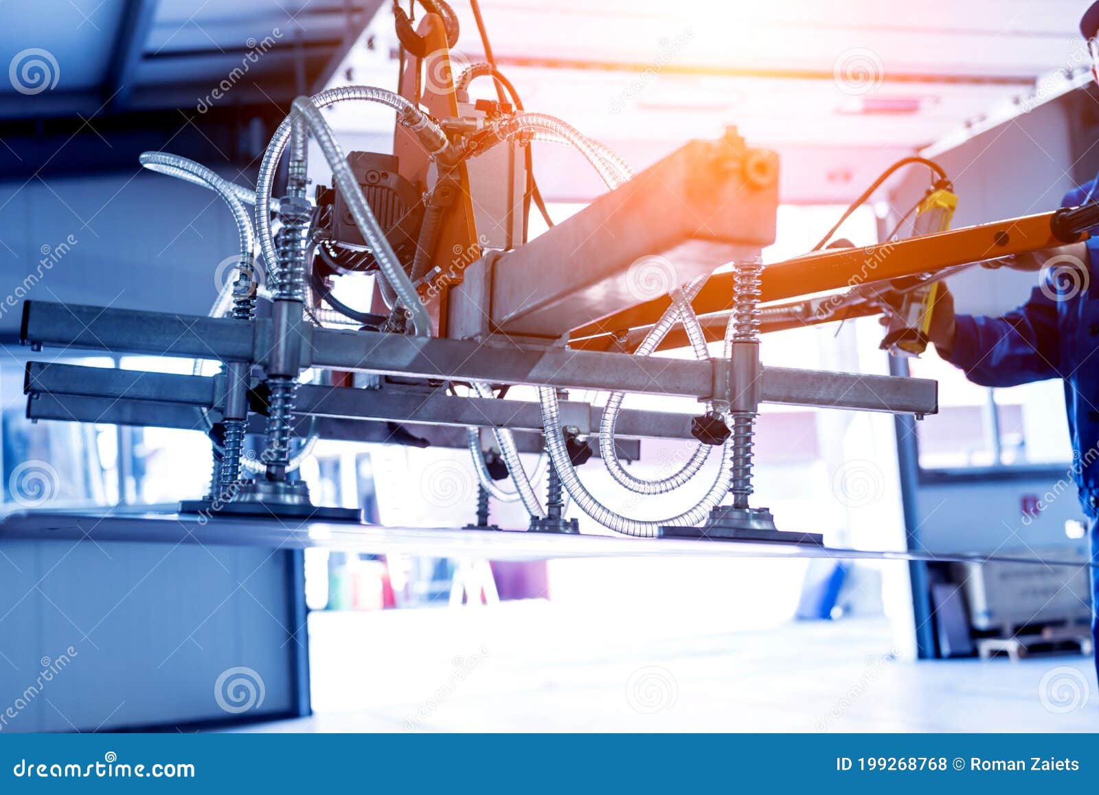 Worker Uses Suction Cups for Transporting Large Sheets of Metal Stock ...
