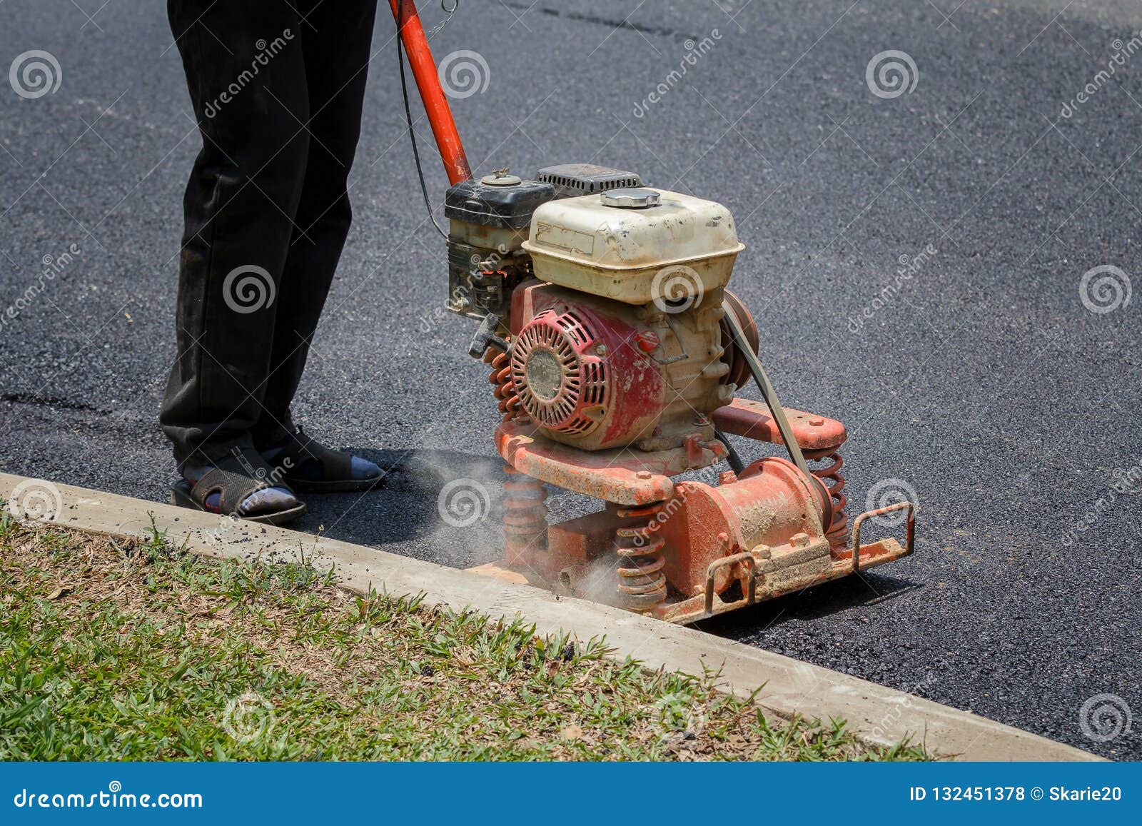 Worker Uses Vibratory Compactor Compacting Asphalt at Road Repair Stock ...