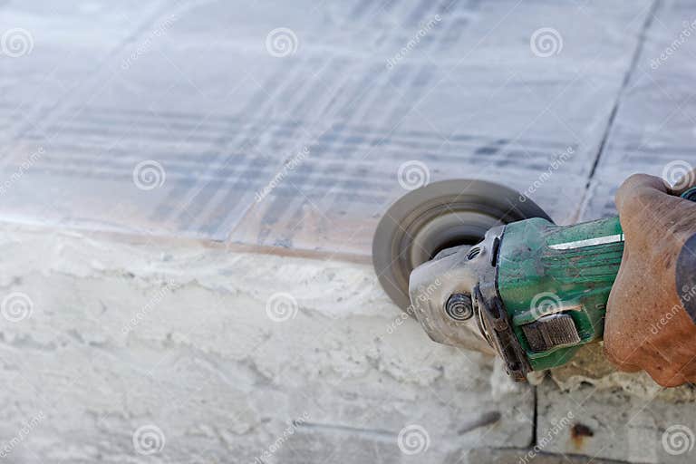 Worker Using an Angle Grinder Cutting Concrete and Tile Stock Photo ...