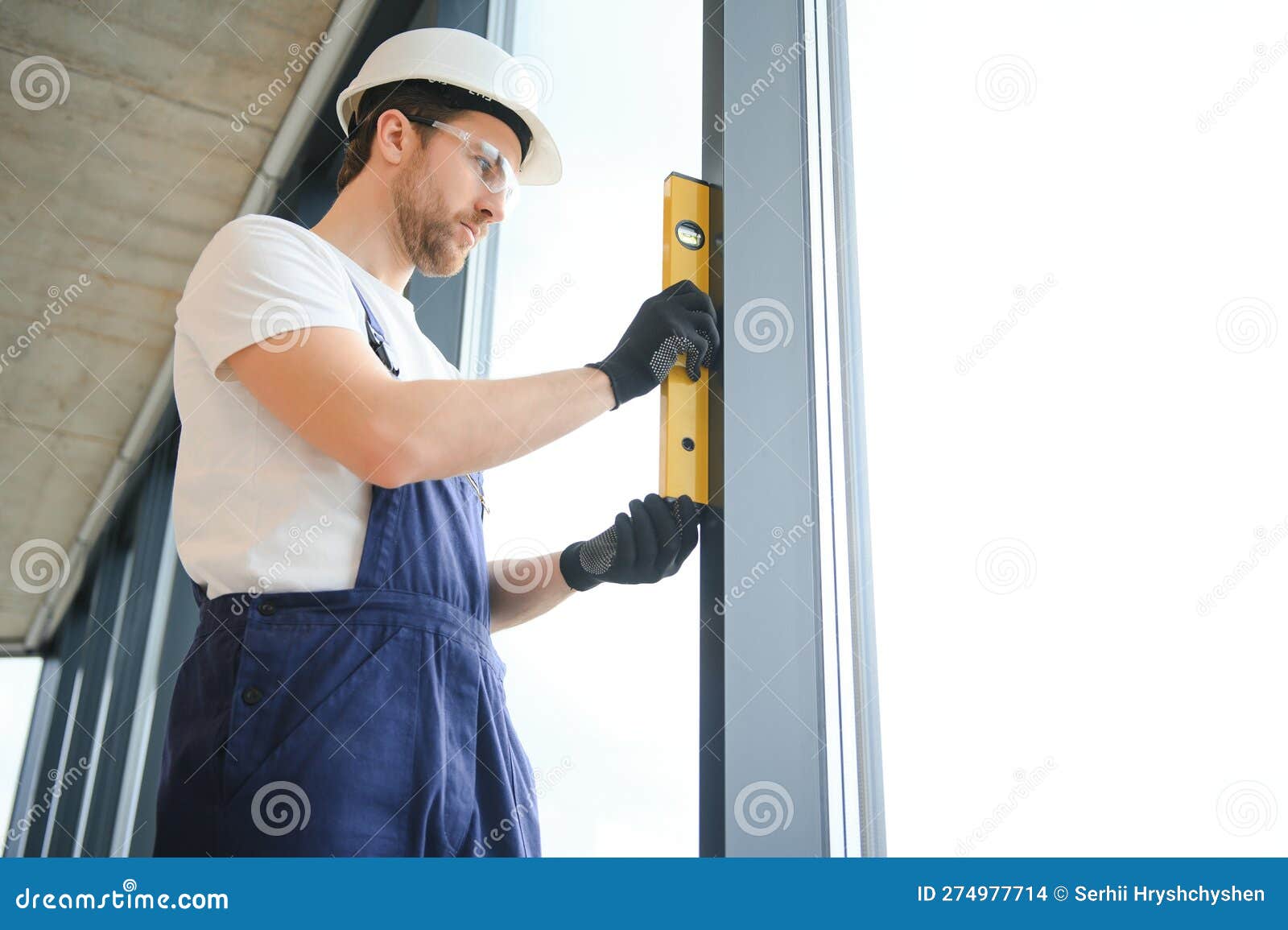 Worker Using Bubble Level after Plastic Window Installation Indoors ...