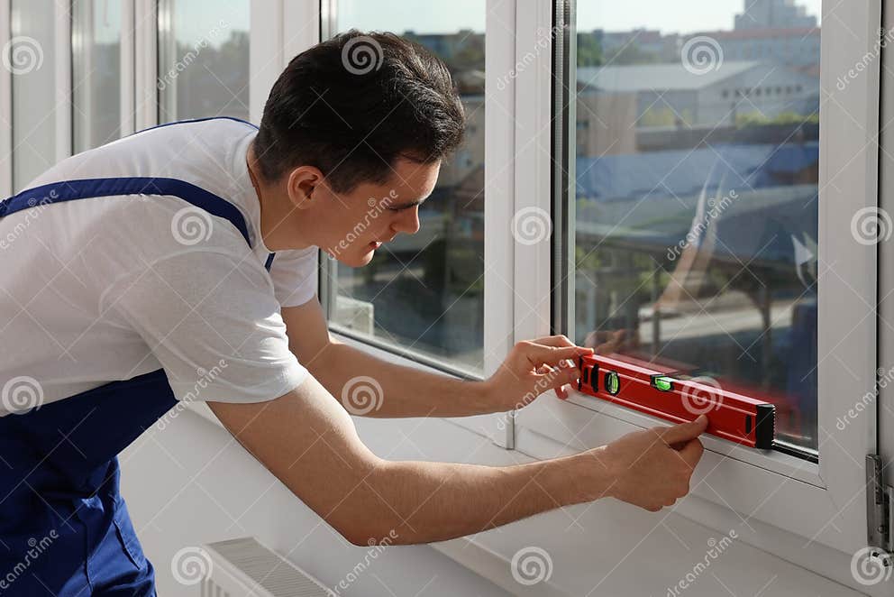 Worker Using Bubble Level after Plastic Window Installation Indoors Stock Photo - Image of frame ...