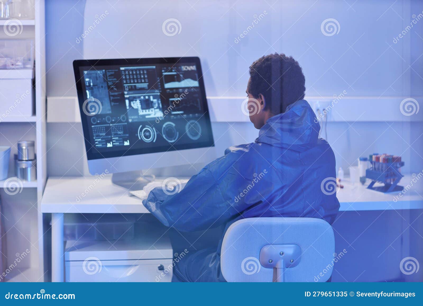 Worker Using Computer with Scientific Data in Laboratory Behind Glass ...