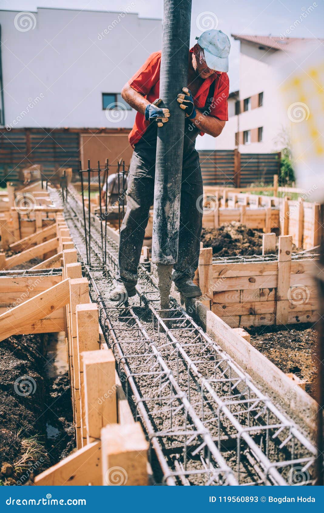 Industrial Worker Using Concrete Pump for Pouring Concrete into ...