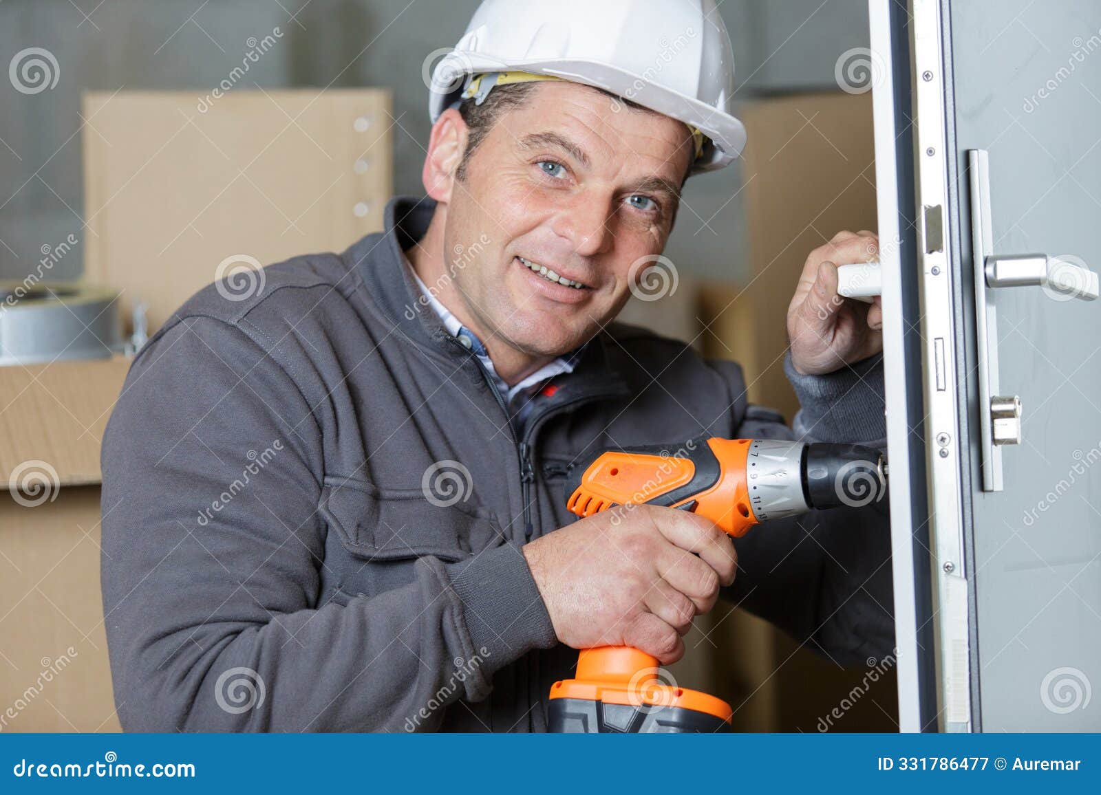 Worker Using Cordless Screwdriver on Door Lock Stock Image - Image of ...