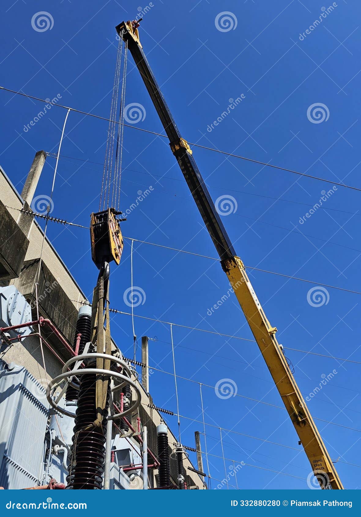 A Worker Using a Crane To Install a Large, Ceramic Electrical Insulator ...