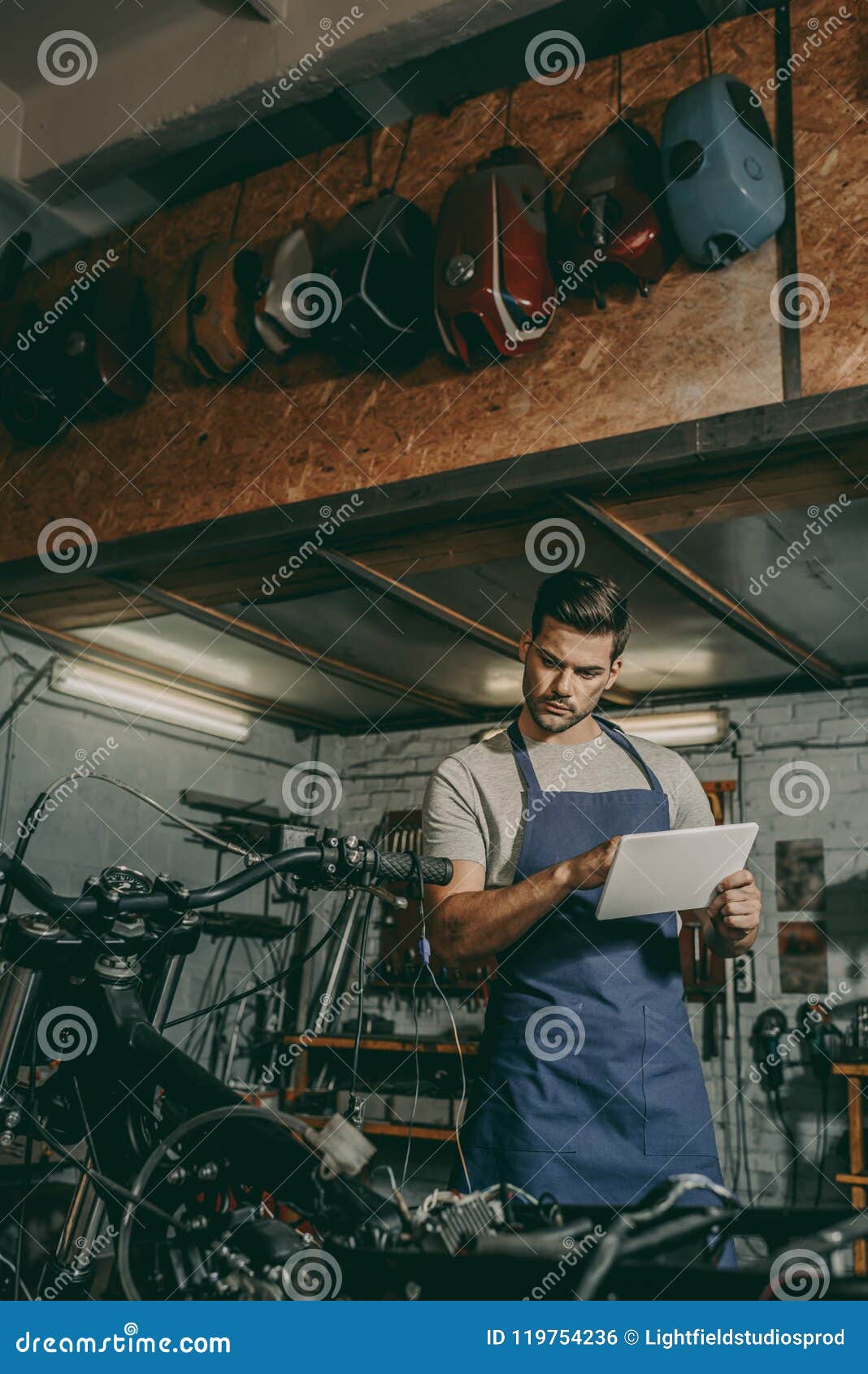 Worker Using Digital Tablet in Repair Shop Stock Photo - Image of ...