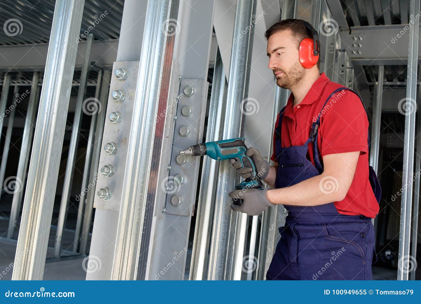 Worker Using a Drill in a Construction Site Stock Image - Image of ...