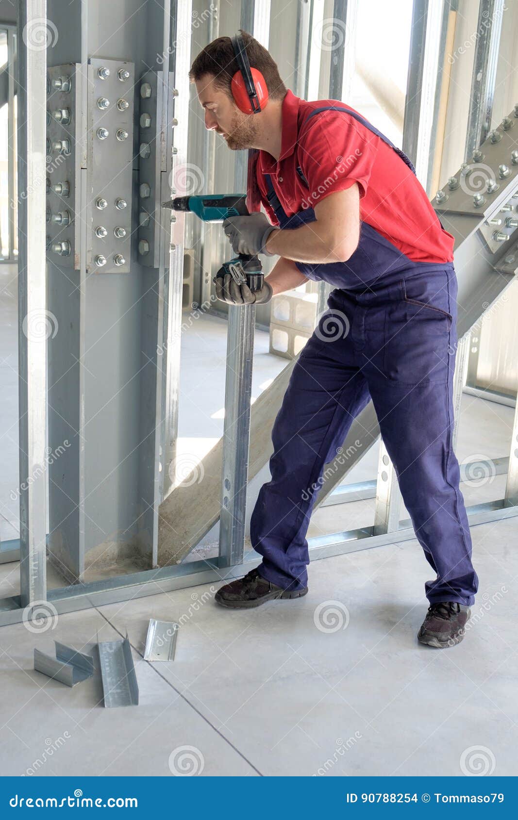 Worker Using a Drill in a Construction Site Stock Photo - Image of ...