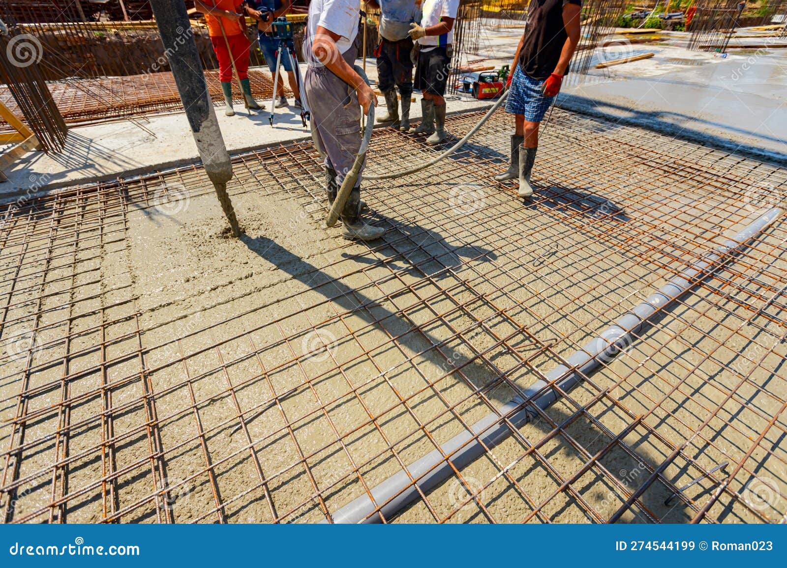 Worker is Using Electric Vibratory To Compact Concrete in Foundation ...